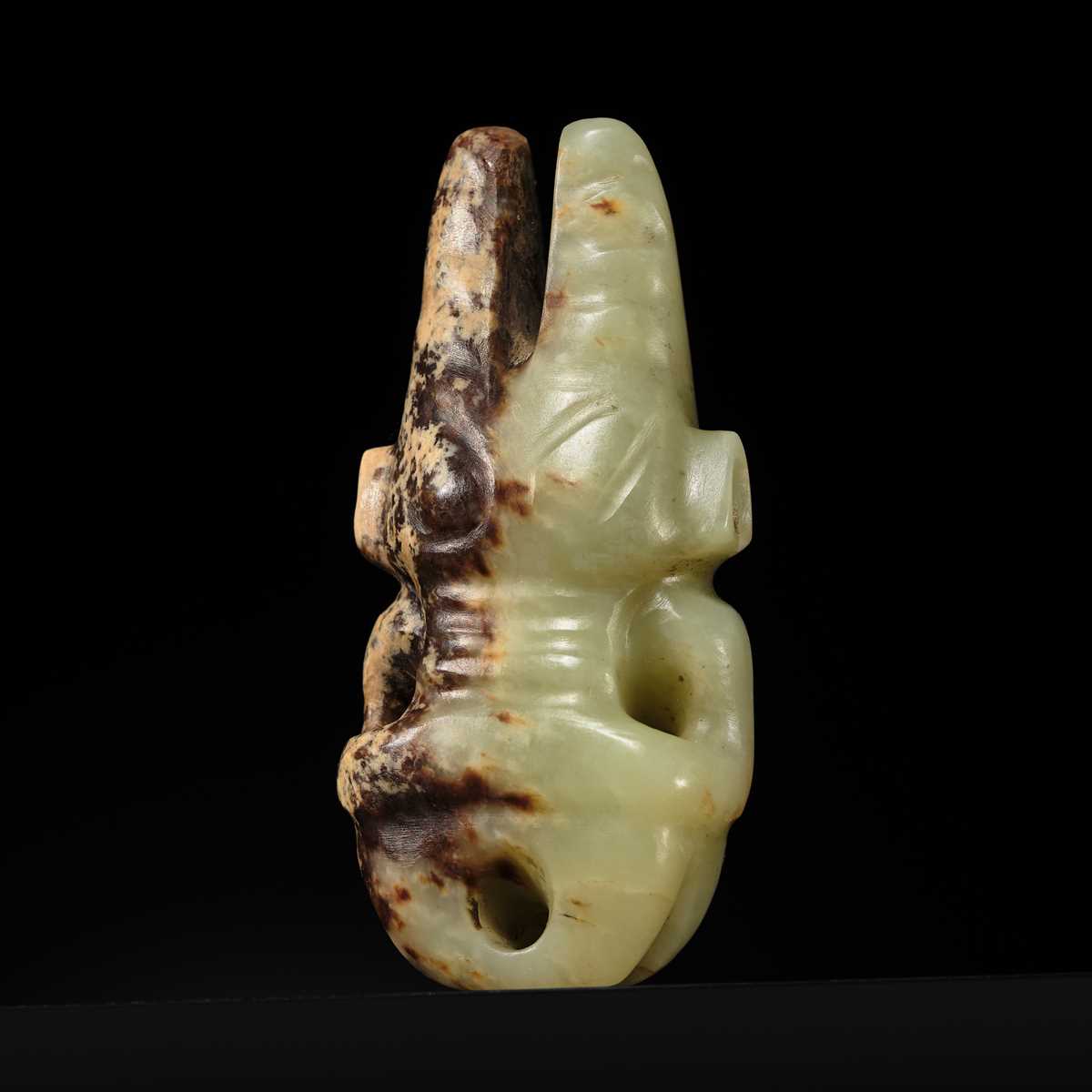 Lot 427 - A RARE CELADON AND BROWN JADE ‘SUN GOD’